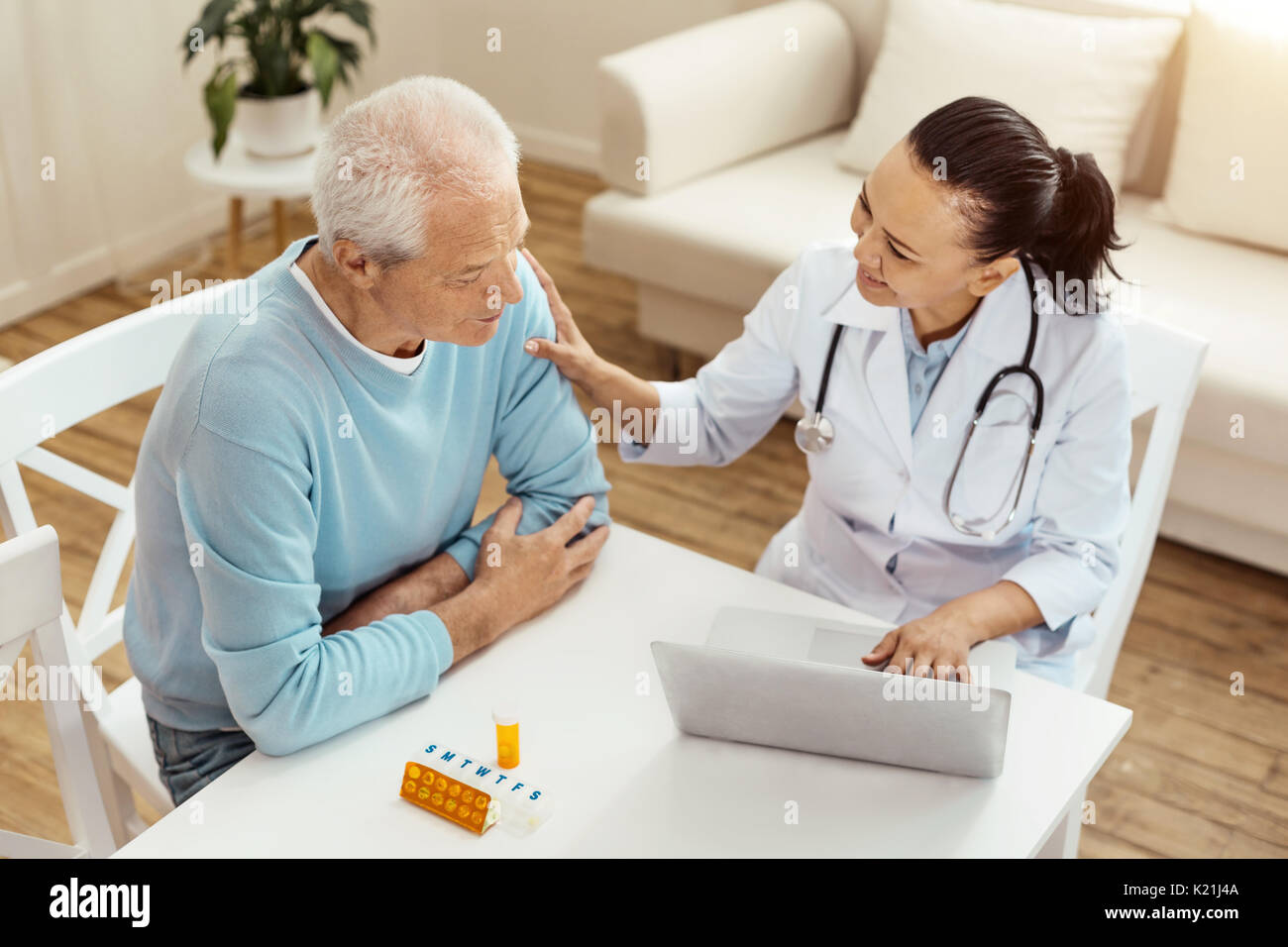 Cheerful friendly doctor comforting her patient Stock Photo - Alamy