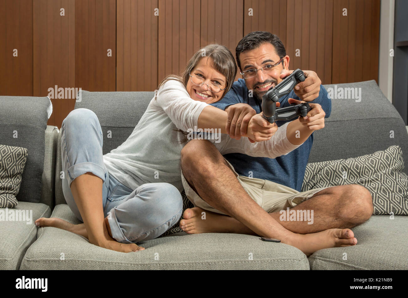 couple playing video games in their city apartment Stock Photo - Alamy