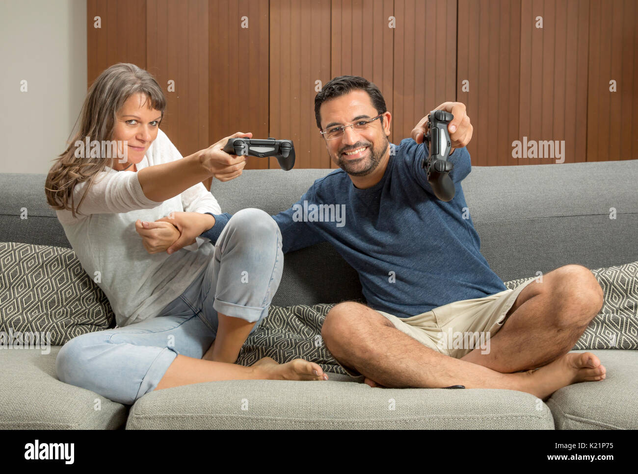 couple playing video games in their city apartment Stock Photo - Alamy