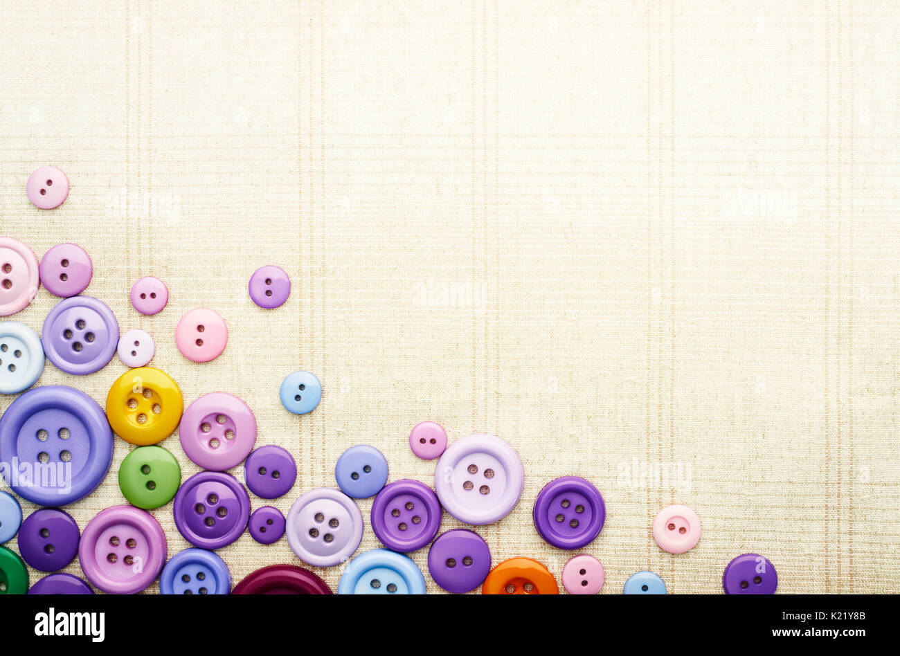 Multi color sewing buttons on the cloth fabric background Stock Photo ...