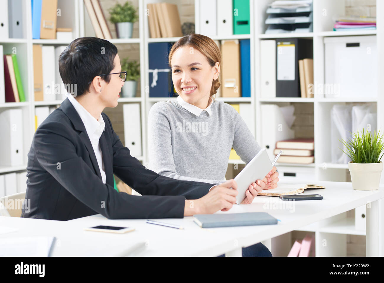 Sharing Creative Ideas with Coworker Stock Photo - Alamy