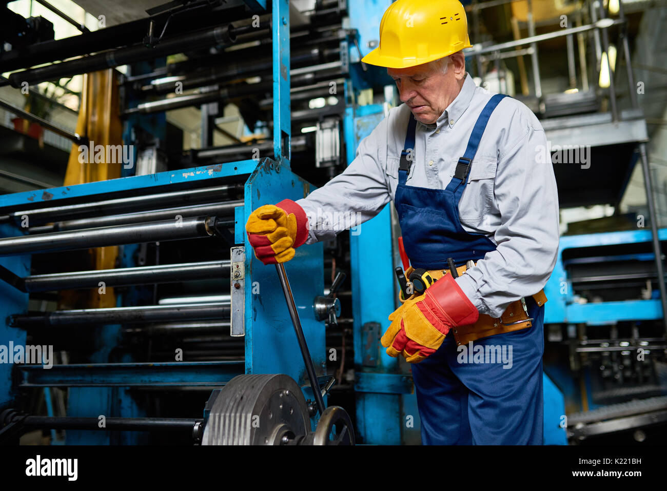 Senior Worker Operating Machines at Factory Stock Photo - Alamy