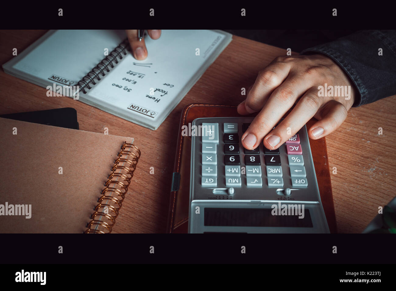 Close up hand Asian man calculate finances and accounting for monthly ...