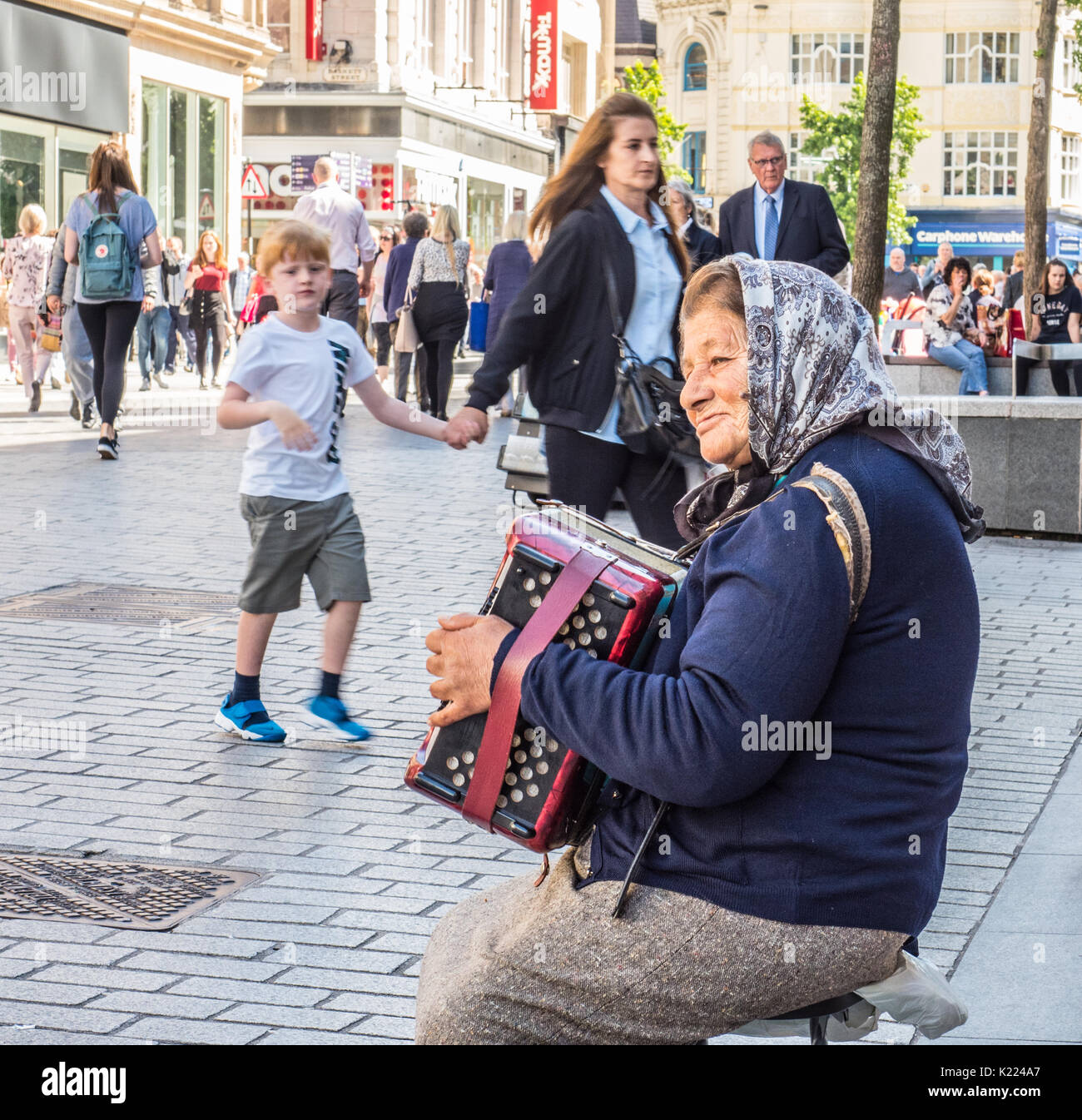 Old woman street busker playing accordion, Liverpool, England, UK Stock ...