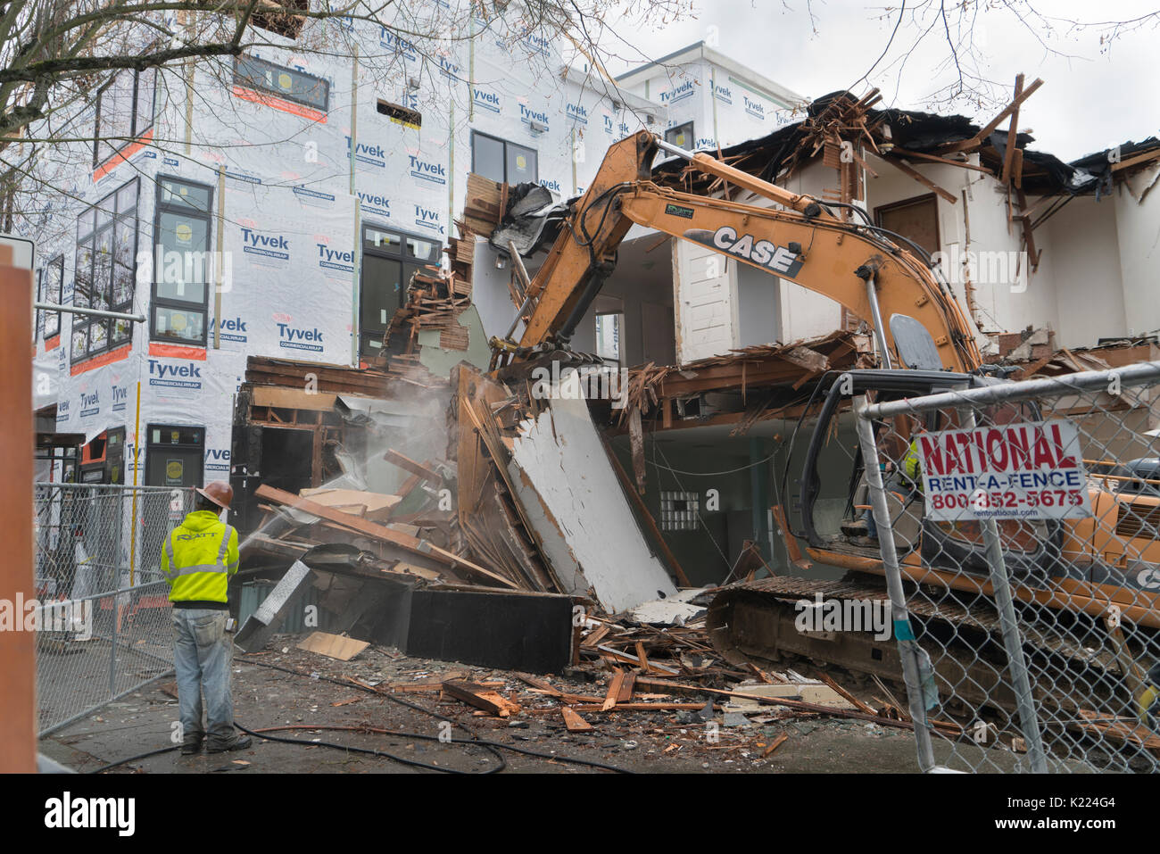 A backhoe demolishing a building Stock Photo - Alamy