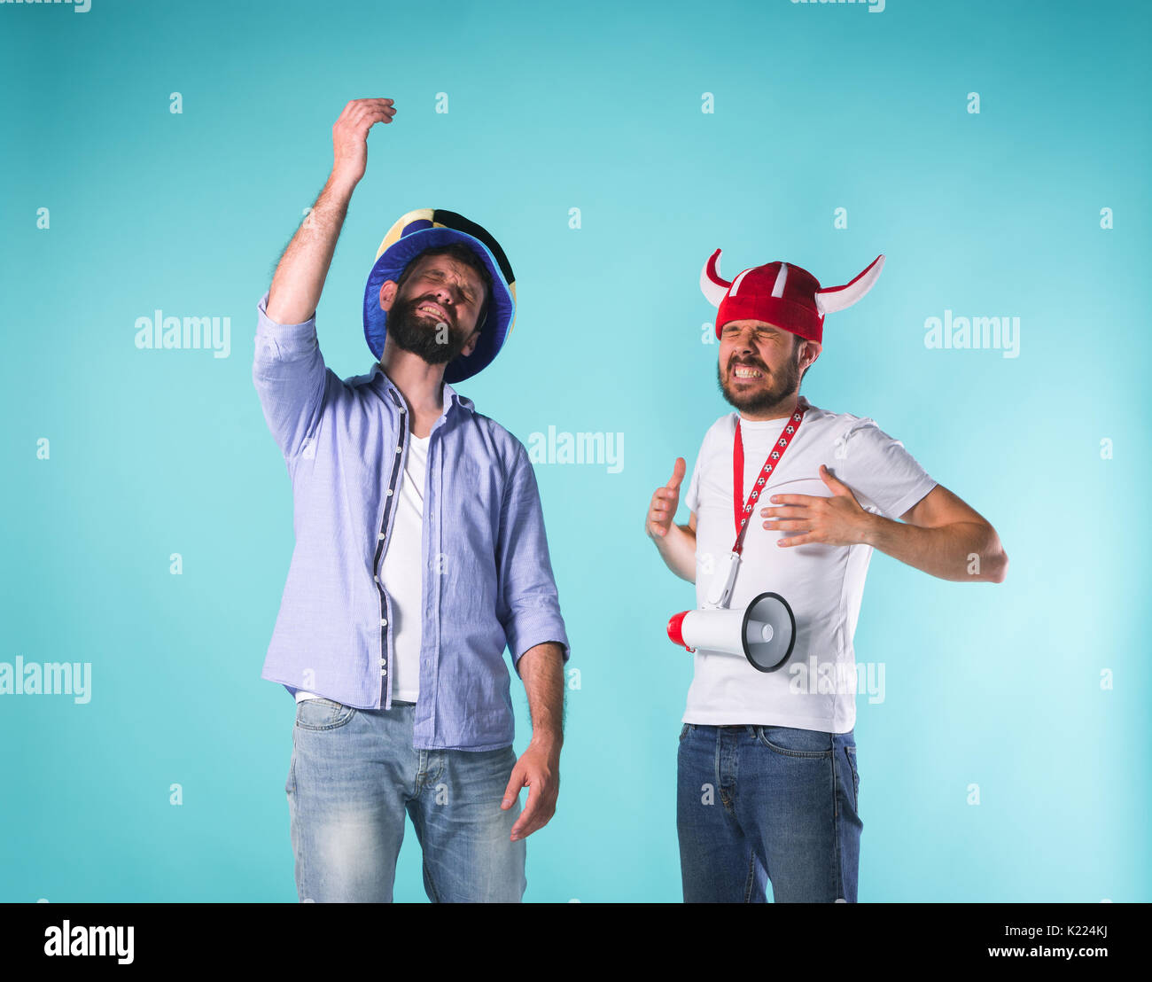 The two football fans over blue Stock Photo - Alamy