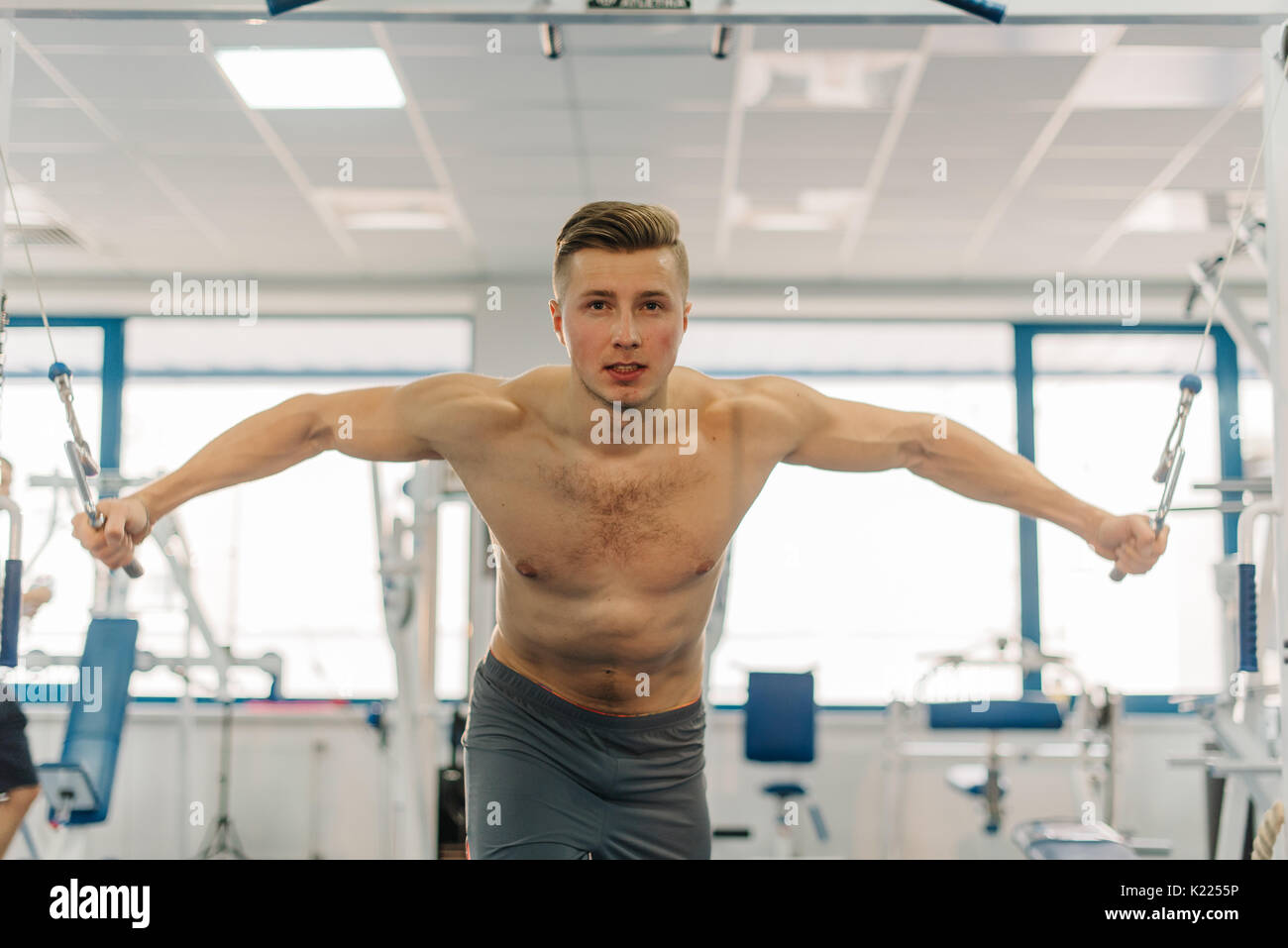 Strongman working out on Fitness-station. Man with six-pack abs. He ...