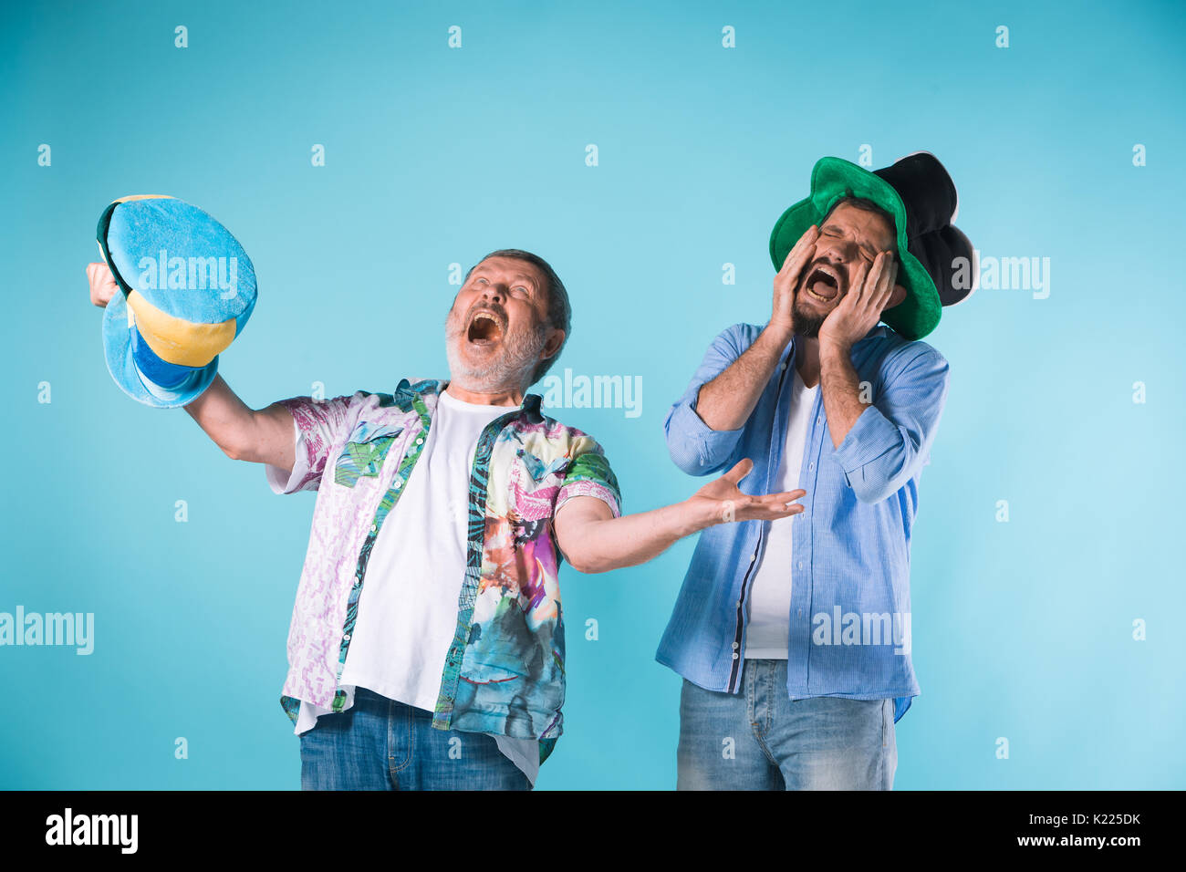 The two football fans over blue Stock Photo - Alamy