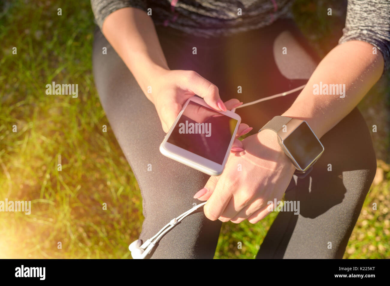 Female athlete using fitness app on her smart watch to monitor workout ...