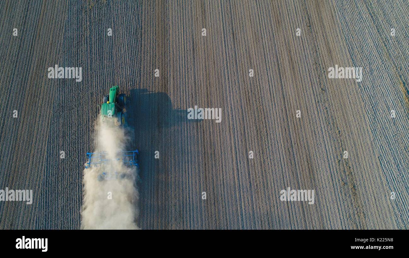 Aerial tractor ploughing agricultural field hi-res stock photography ...