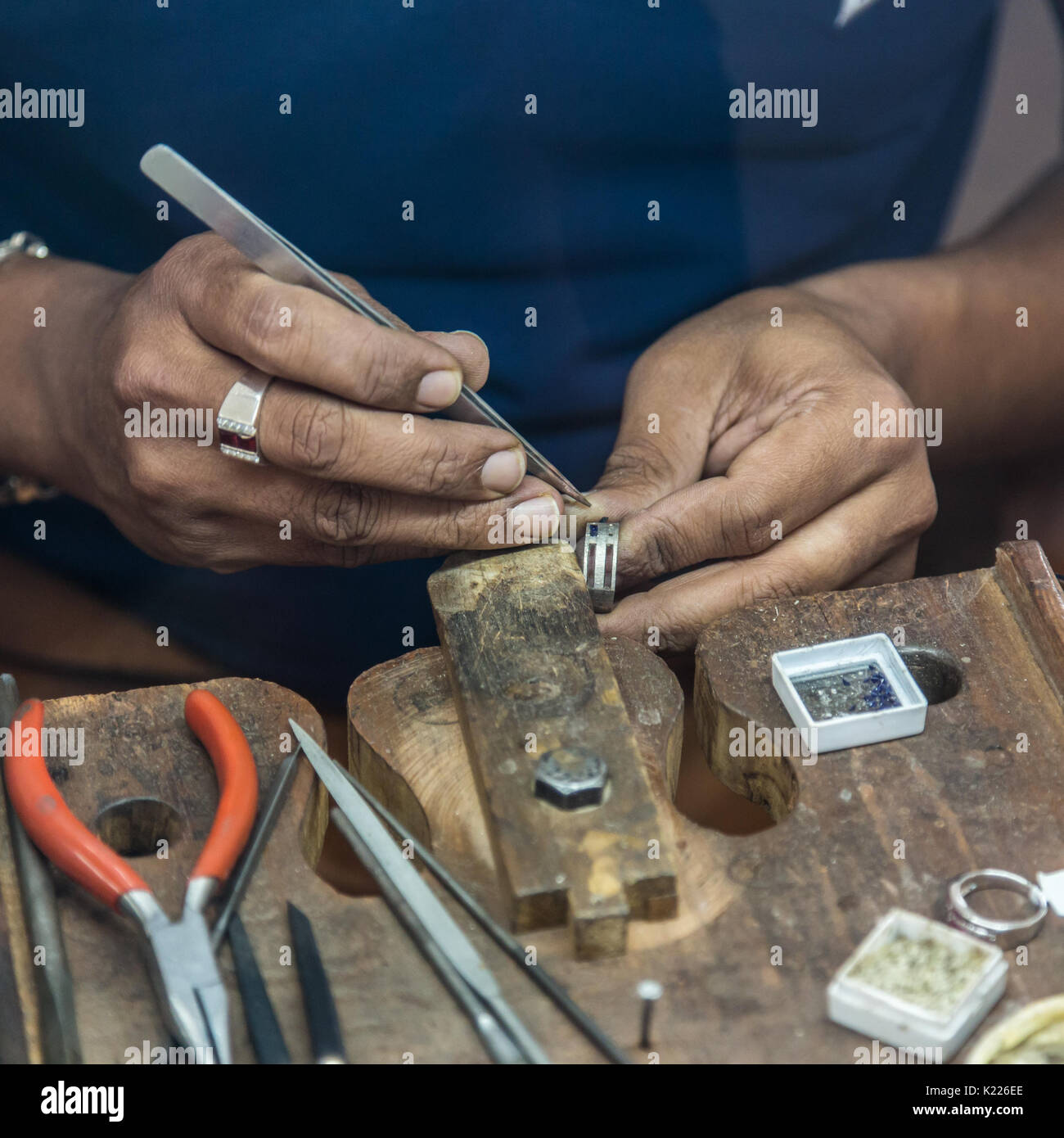 Jeweler making handmade jewelry on vintage workbench Stock Photo - Alamy