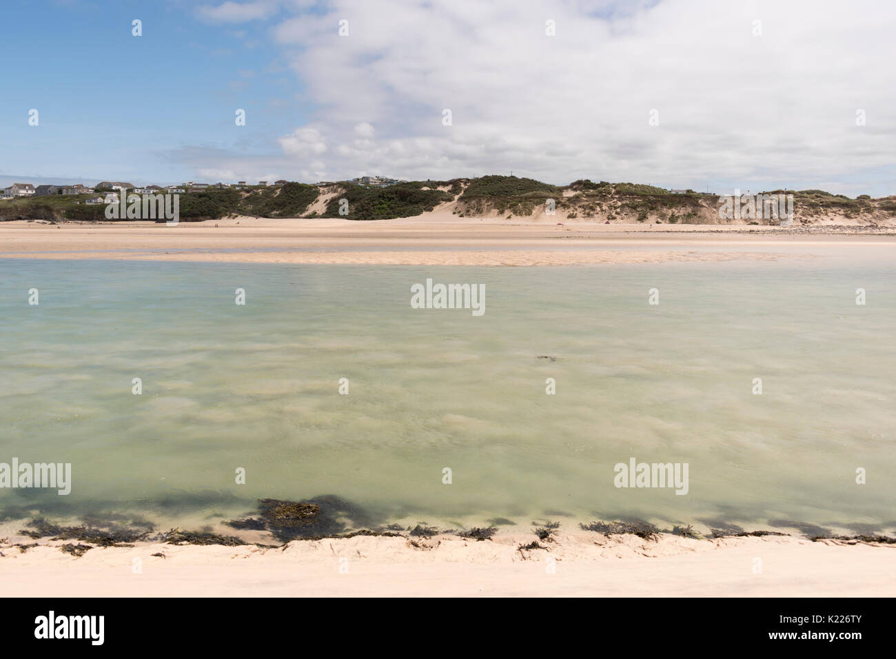 Estuary waters running into the sea at North Kidney Beach near Lelant ...
