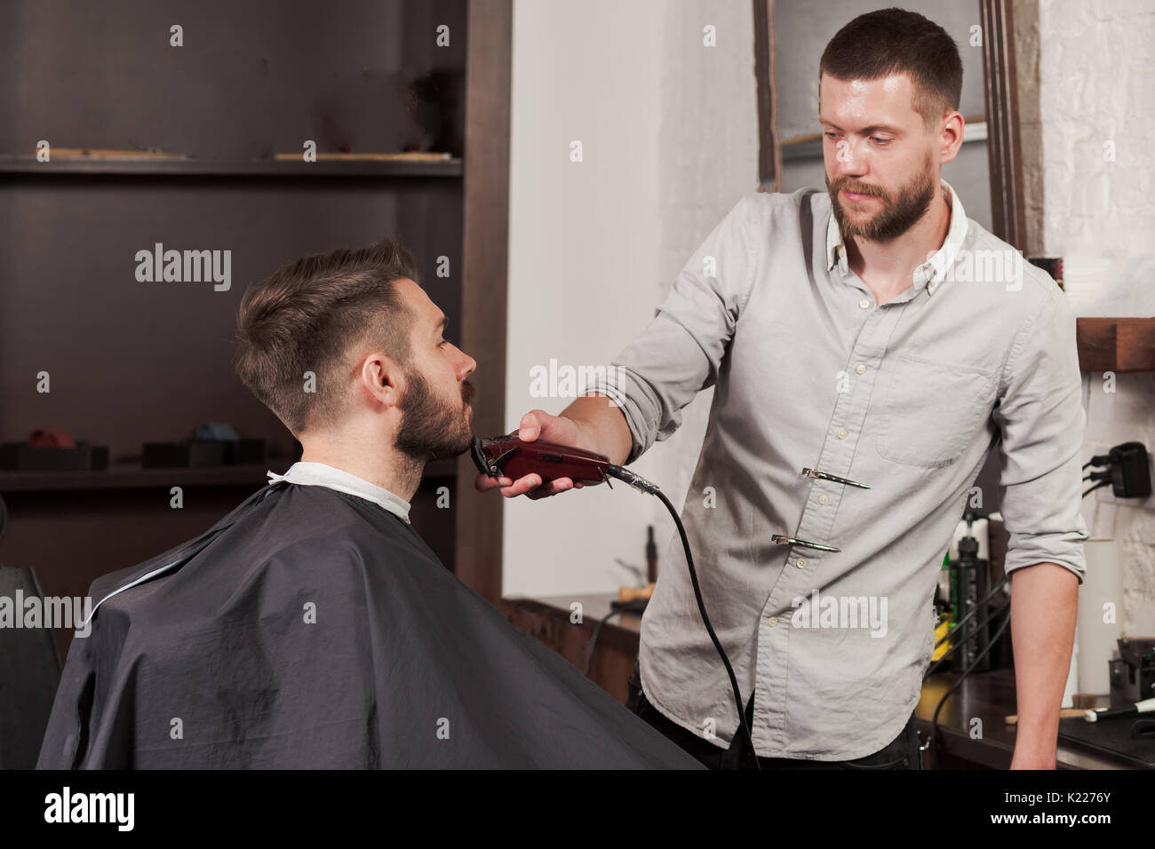 Hipster client visiting barber shop Stock Photo - Alamy