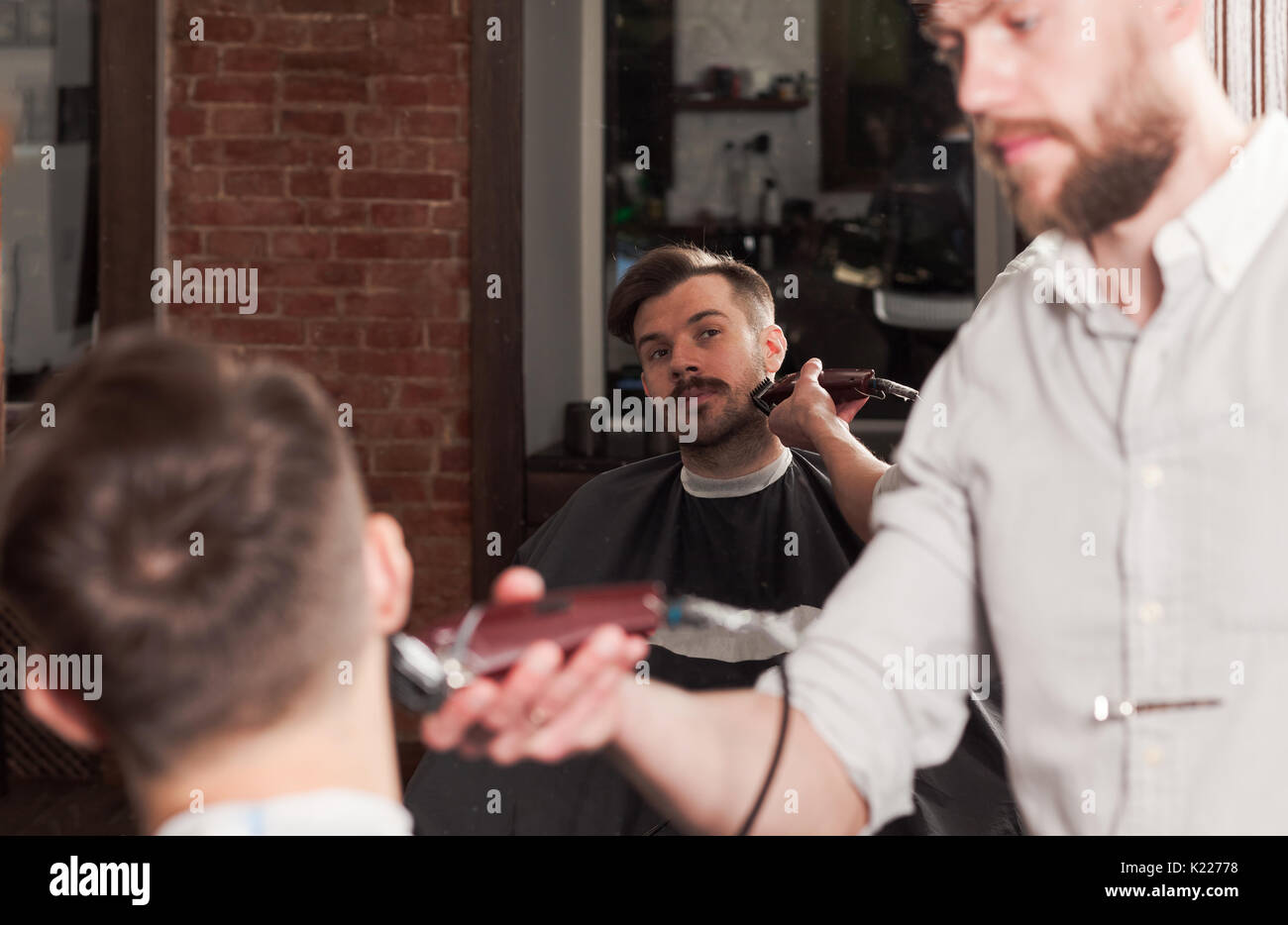 Hipster client visiting barber shop Stock Photo - Alamy