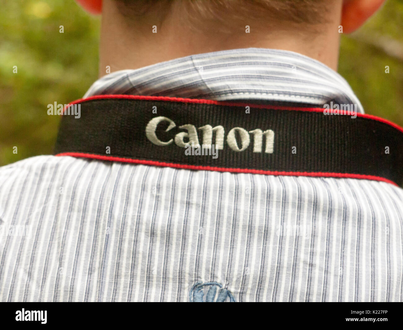 canon strap camera around neck behind safety hanging close up; England ...