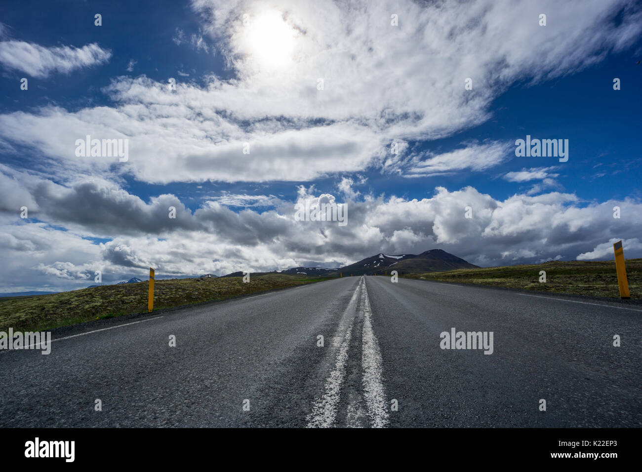 Iceland - Sunshine over straight road between icelandic volcanic ...