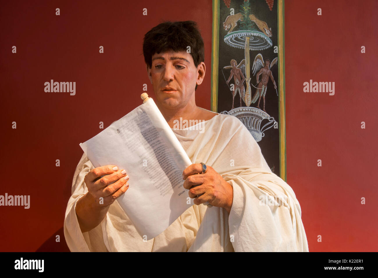 Diorama showing life-size figure in white toga reading papyrus scroll ...