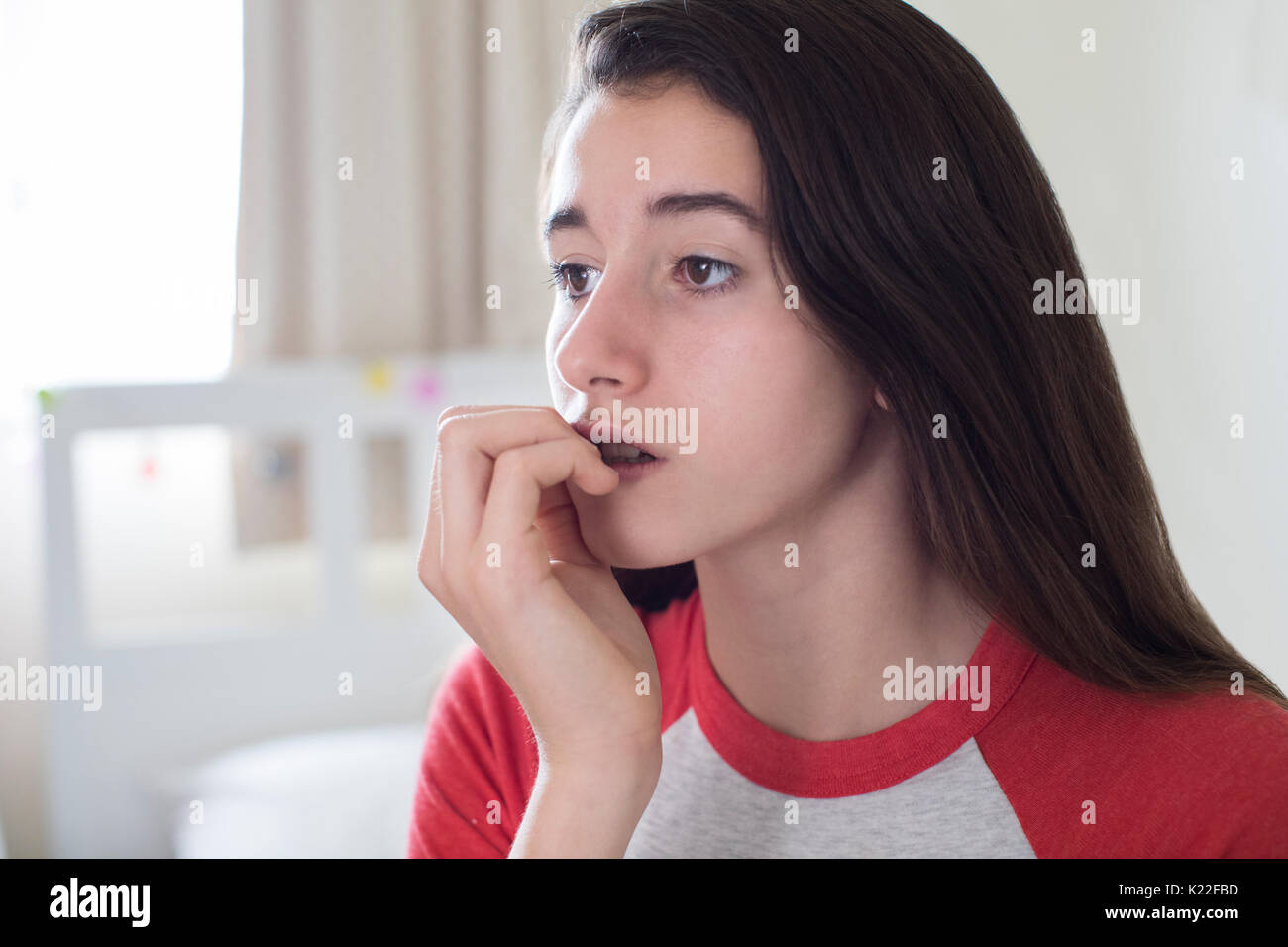 Girl biting her nail hi-res stock photography and images - Alamy