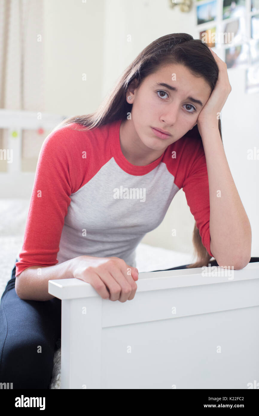 Portrait Of Stressed Teenage Girl In Bedroom Stock Photo - Alamy