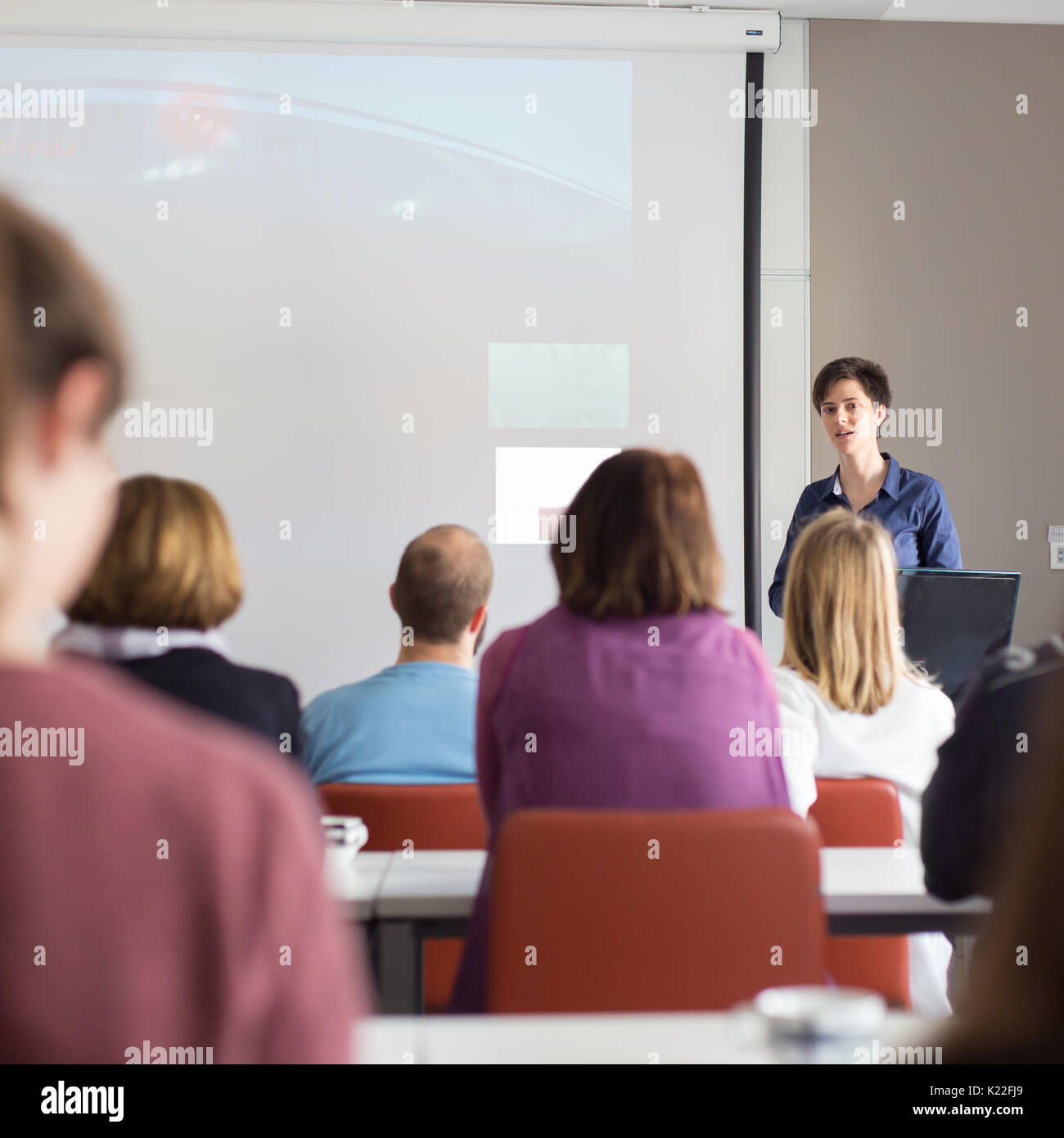 Woman giving presentation in lecture hall at university Stock Photo - Alamy