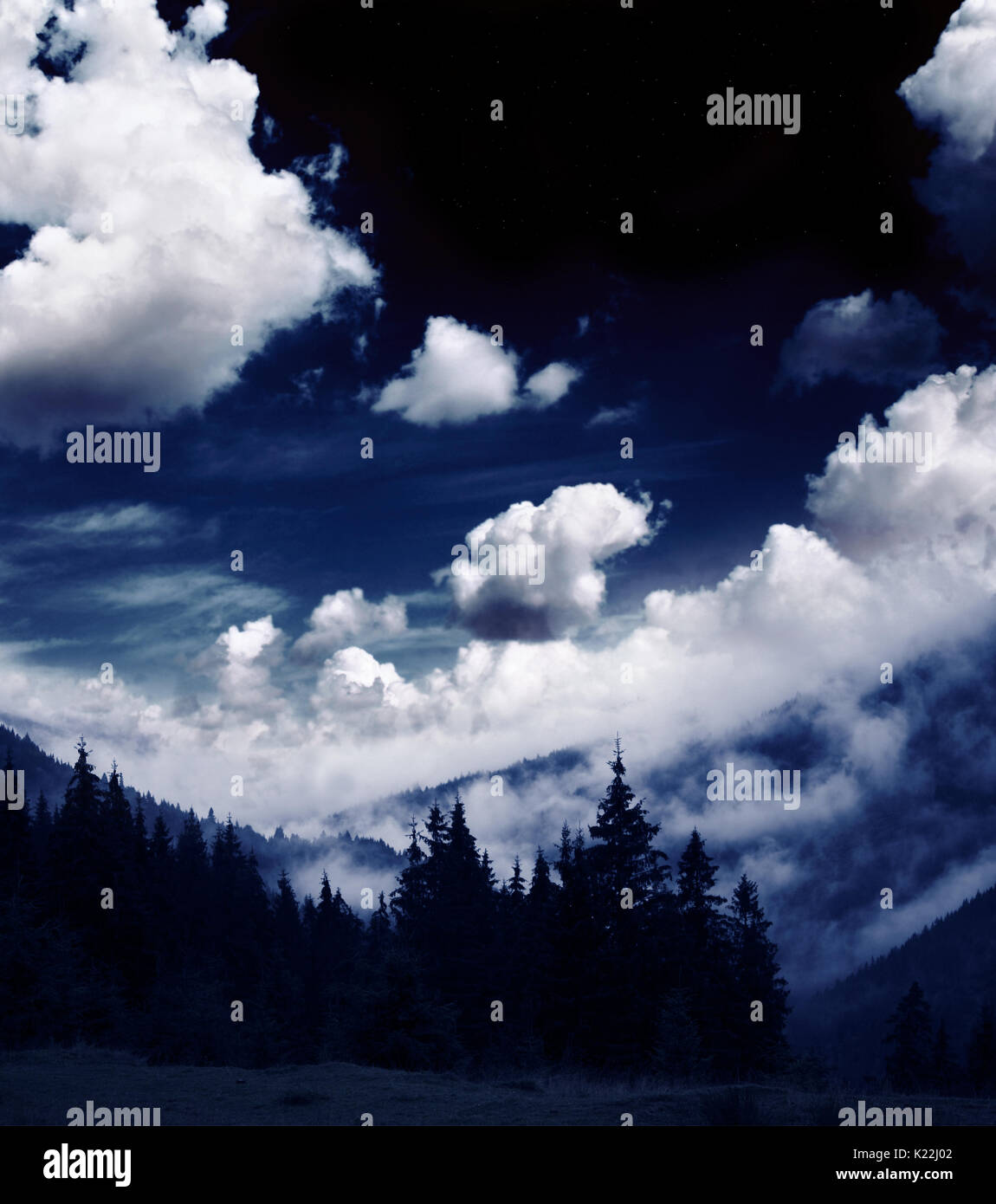 Mysterious landscape of foggy mountain and night sky. Photo toned in ...