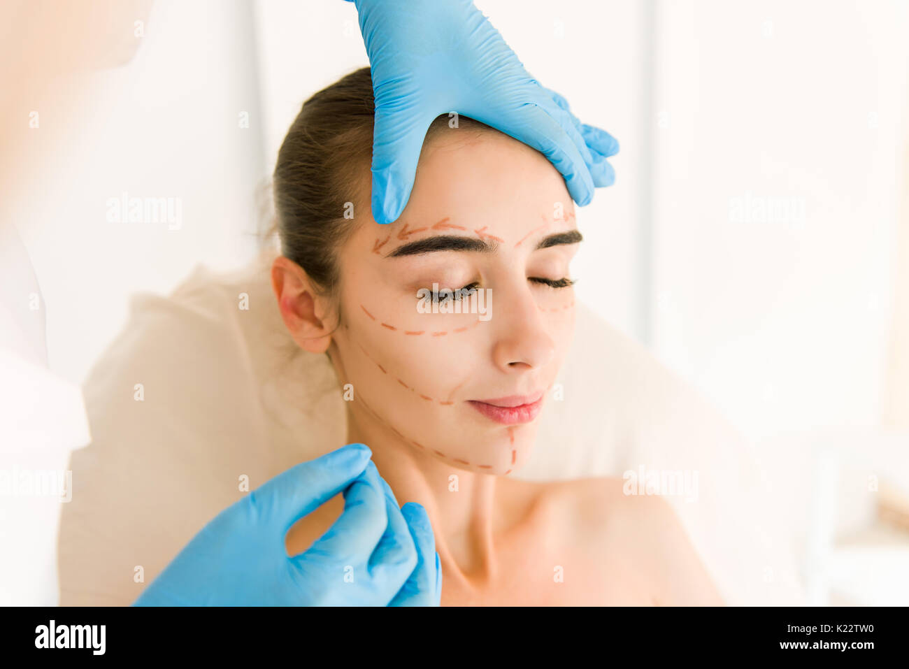 Skin check before plastic surgery. Beautician touch and draw correction ...