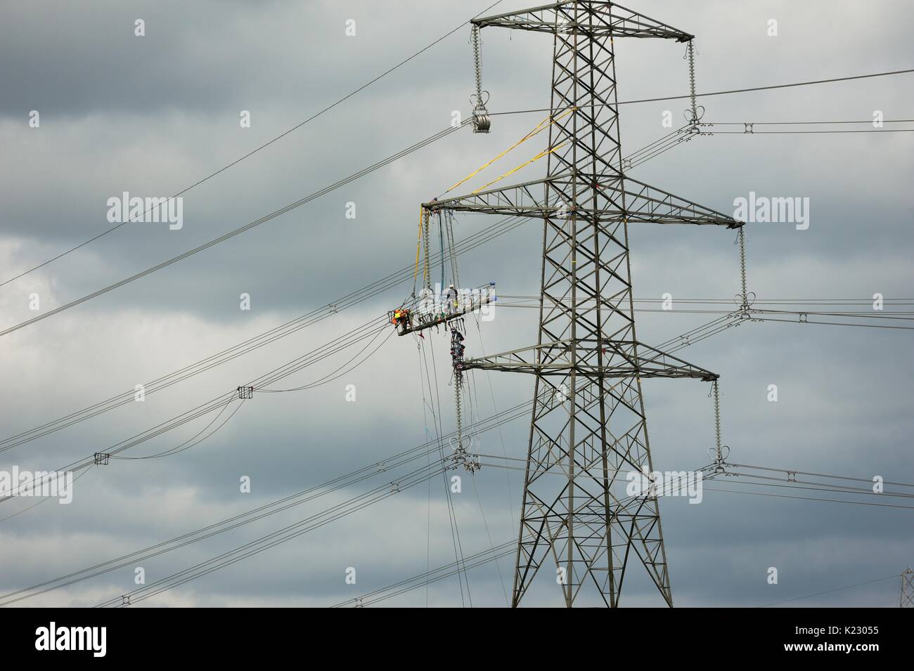 Workers on a platform on an electricity Tower Stock Photo - Alamy