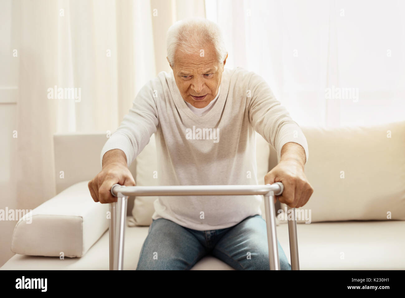 Nice elderly man using a walker Stock Photo - Alamy