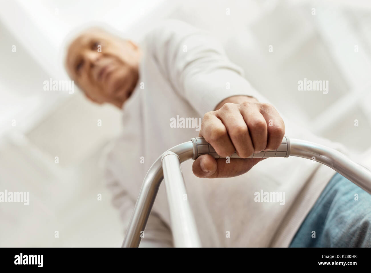 Selective focus of a hand holding the walker Stock Photo - Alamy