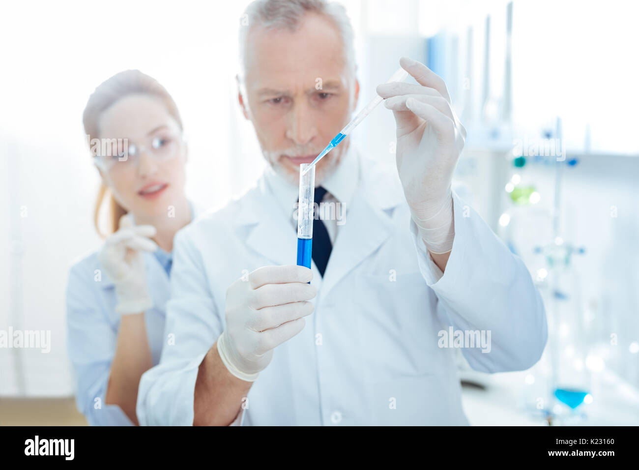 Competent scientist doing difficult experiment Stock Photo - Alamy
