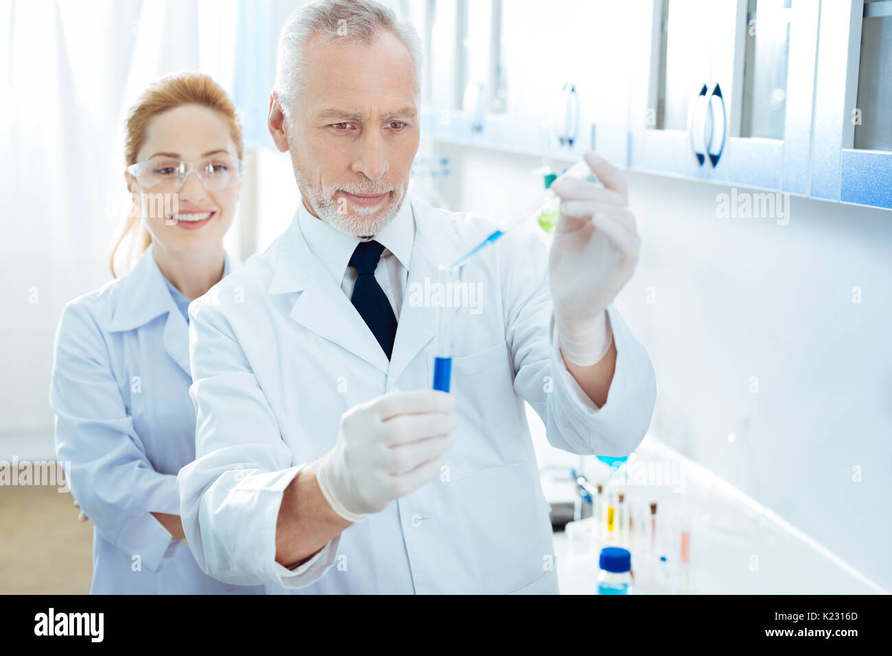 Professional delighted colleagues standing hi-res stock photography and ...