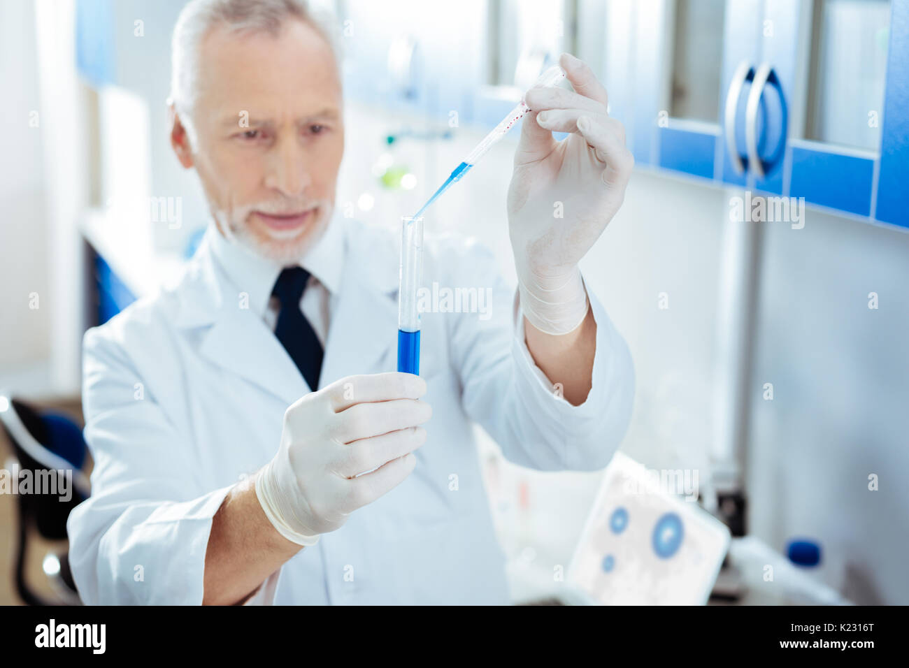 Attentive male person doing his task with pleasure Stock Photo - Alamy