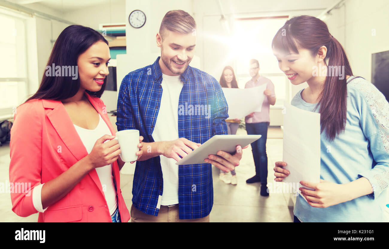 creative team with tablet pc and papers at office Stock Photo - Alamy