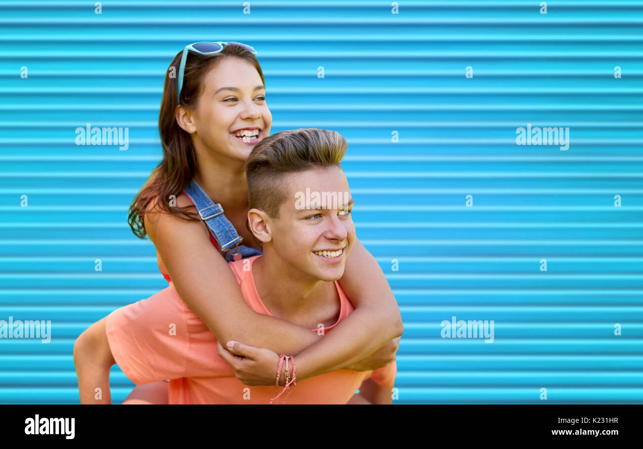 happy teenage couple having fun over blue Stock Photo - Alamy