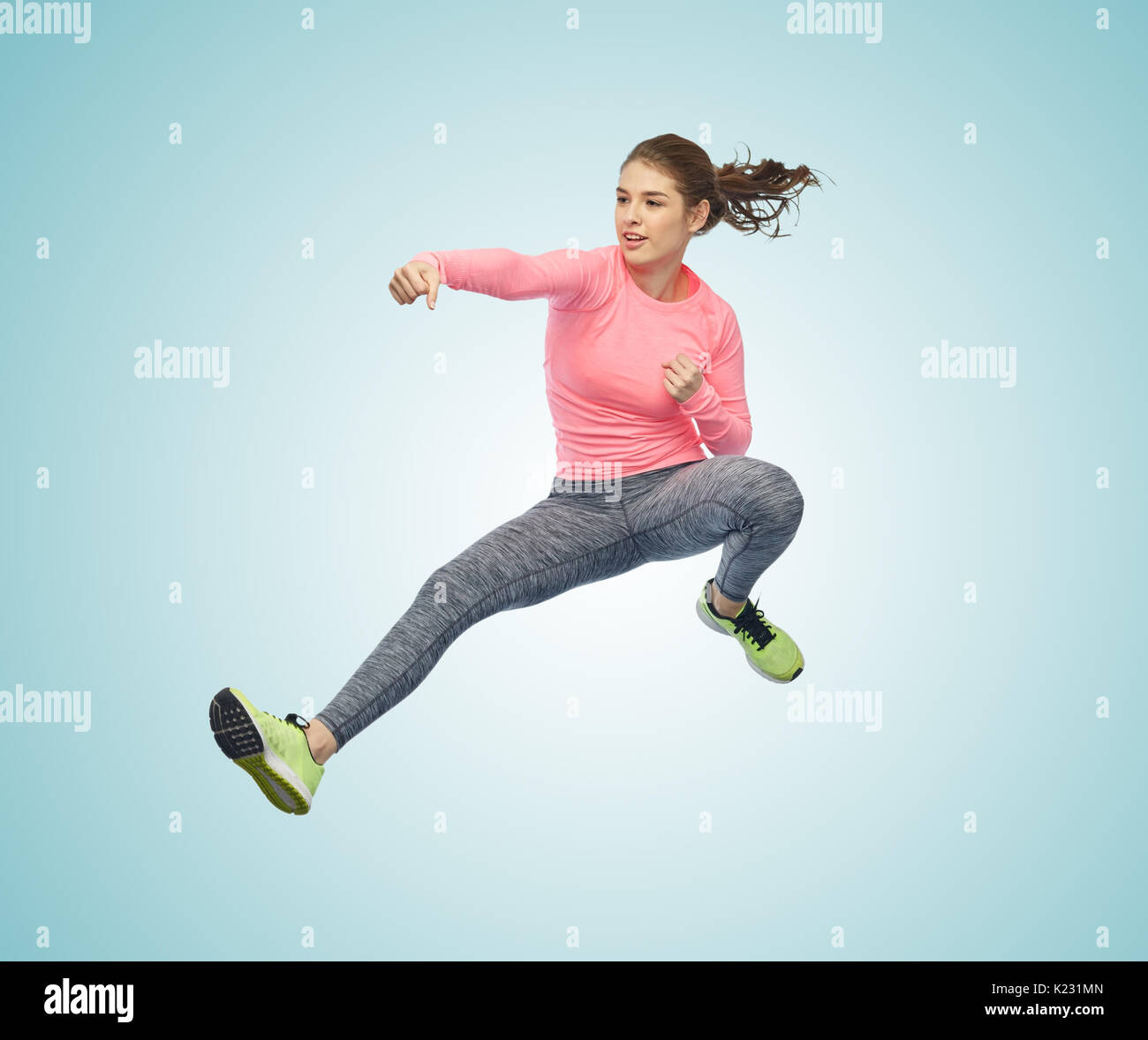 happy sporty young woman jumping in fighting pose Stock Photo - Alamy