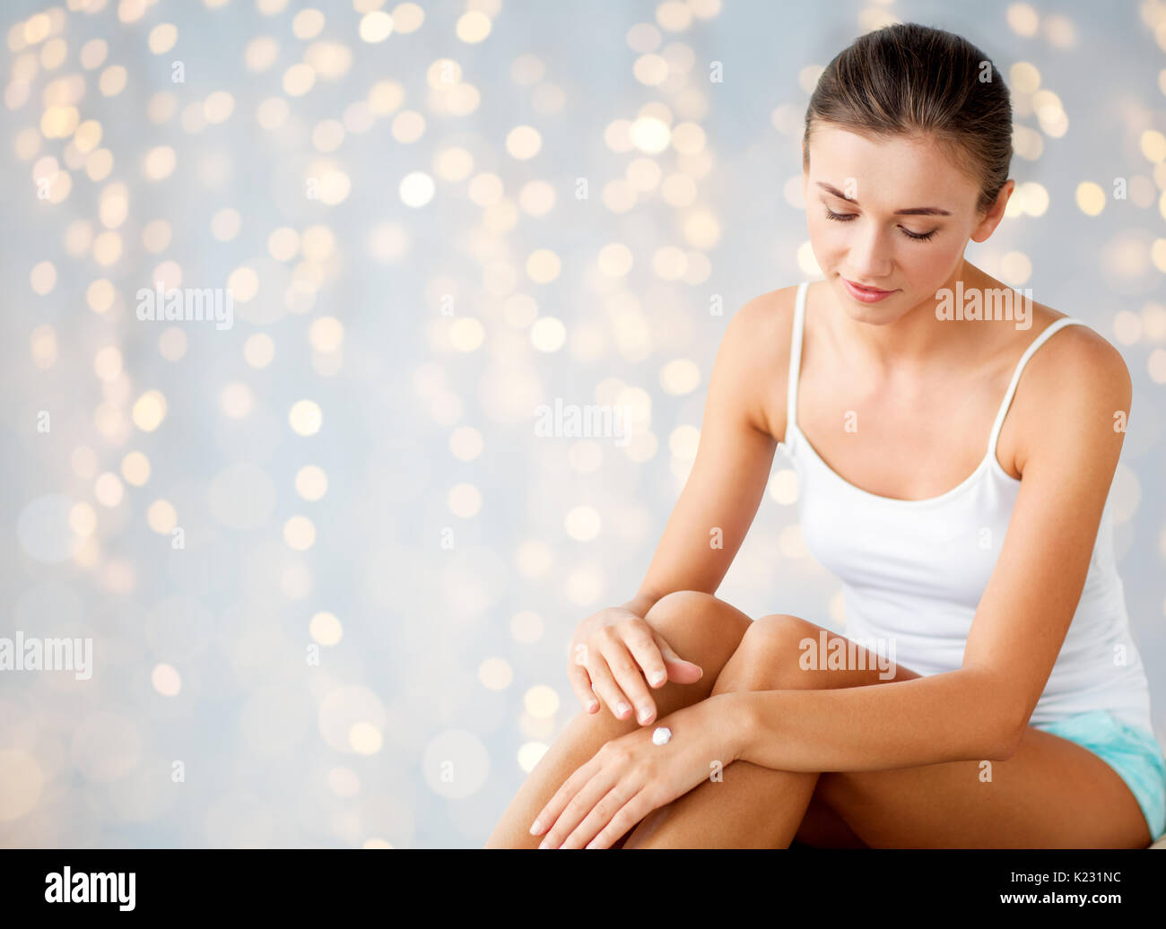 beautiful woman applying hand cream at home Stock Photo - Alamy