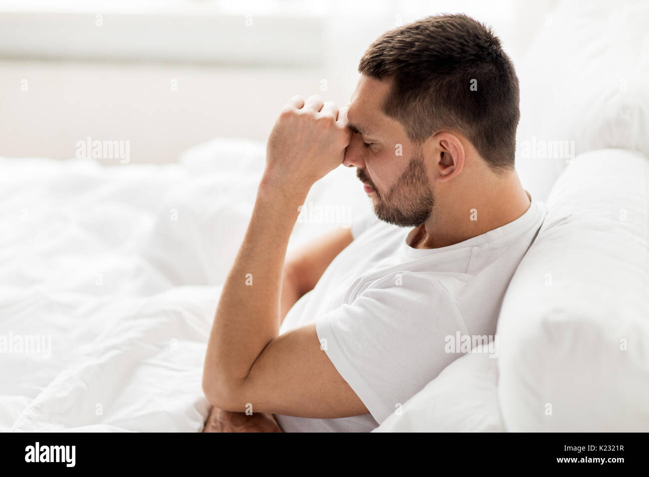 stressed man in bed at home Stock Photo - Alamy