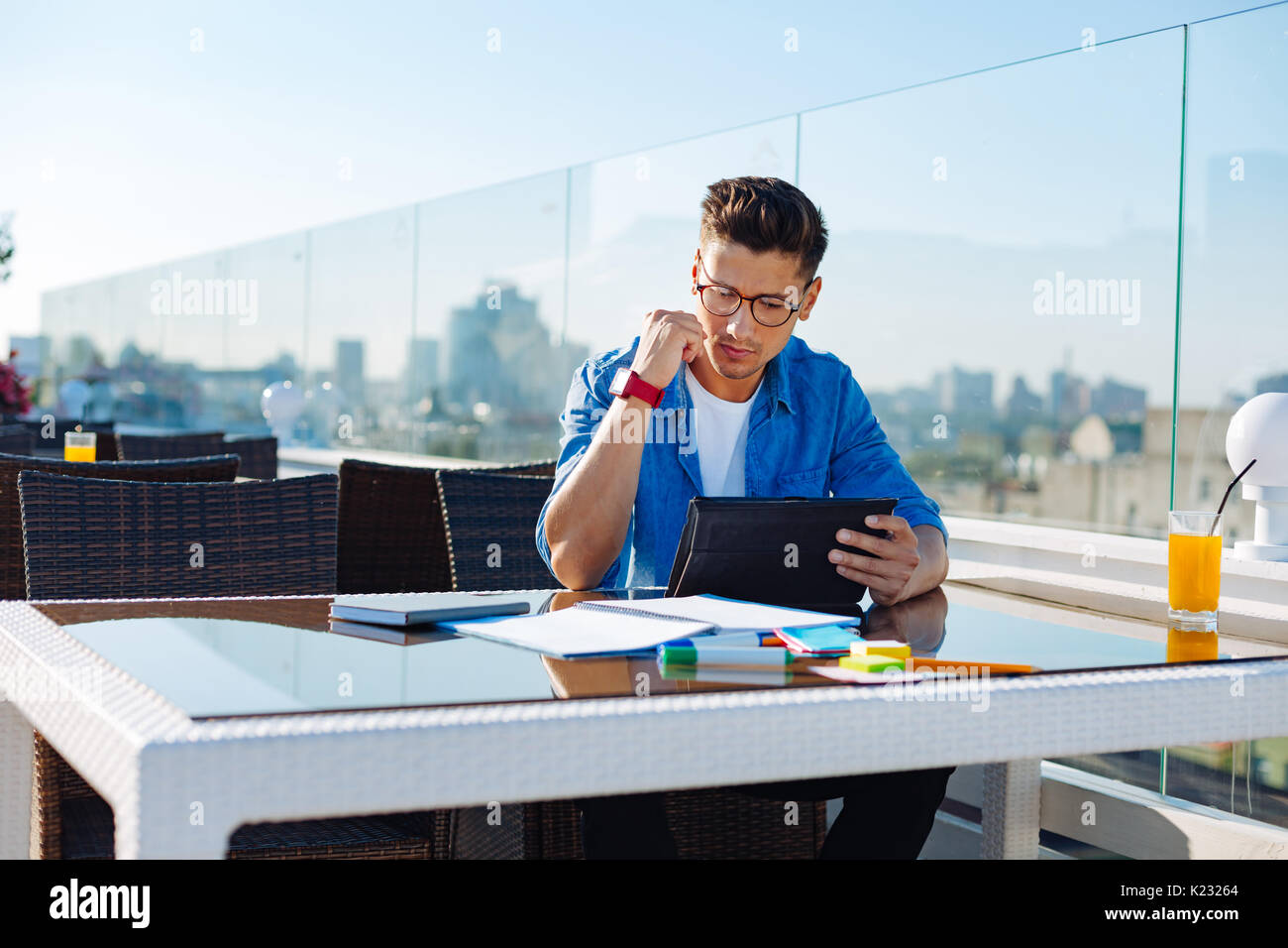 Serious college student working on tablet computer Stock Photo - Alamy