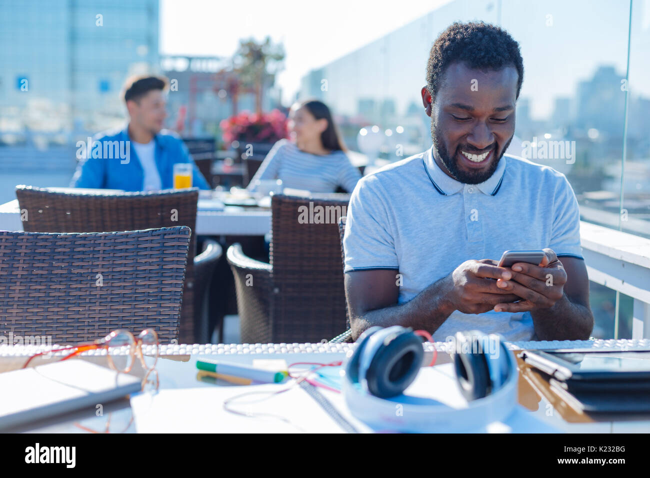 Attractive young man typing message on phone Stock Photo - Alamy