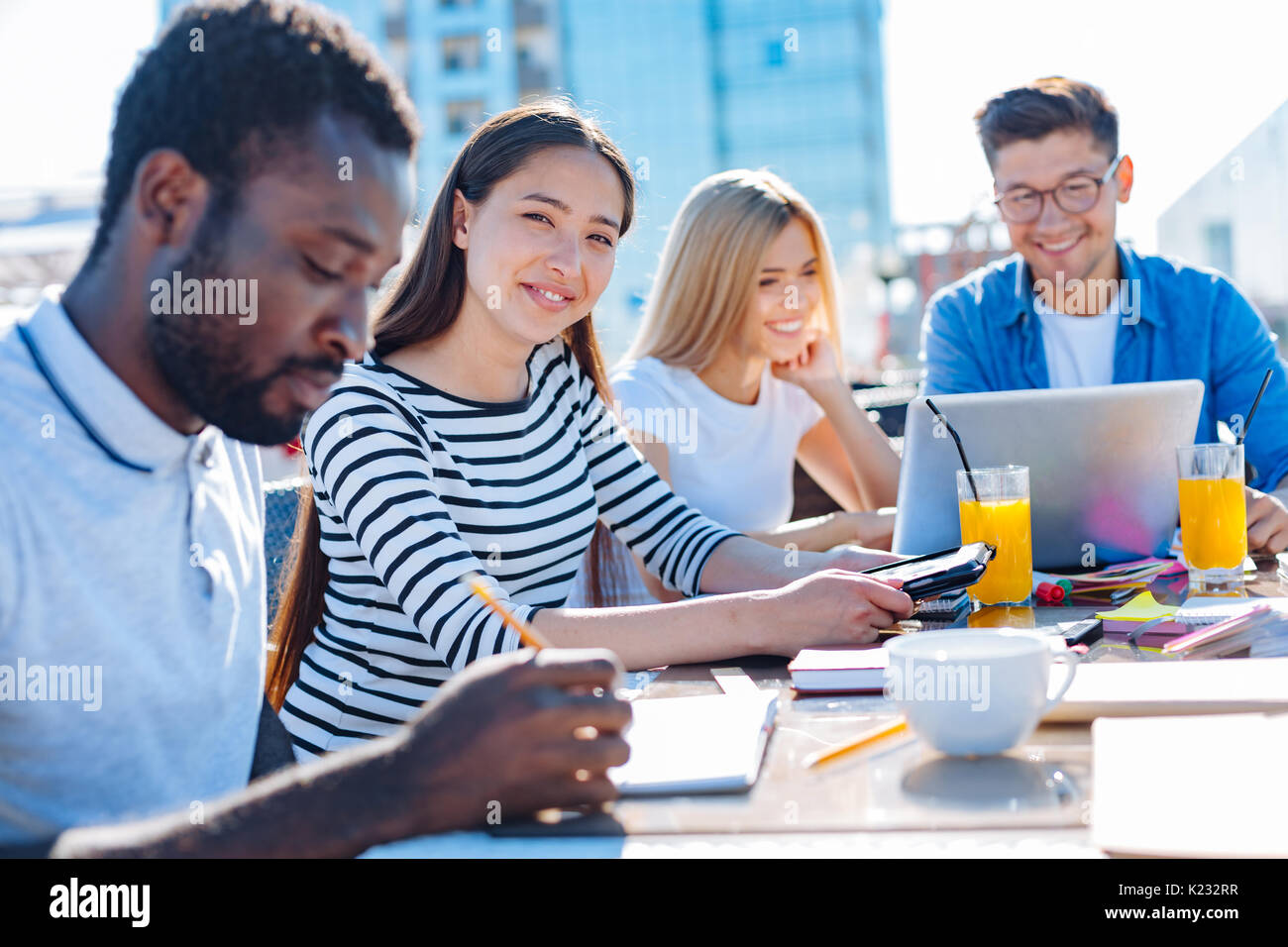 Young and coming professionals working together Stock Photo - Alamy