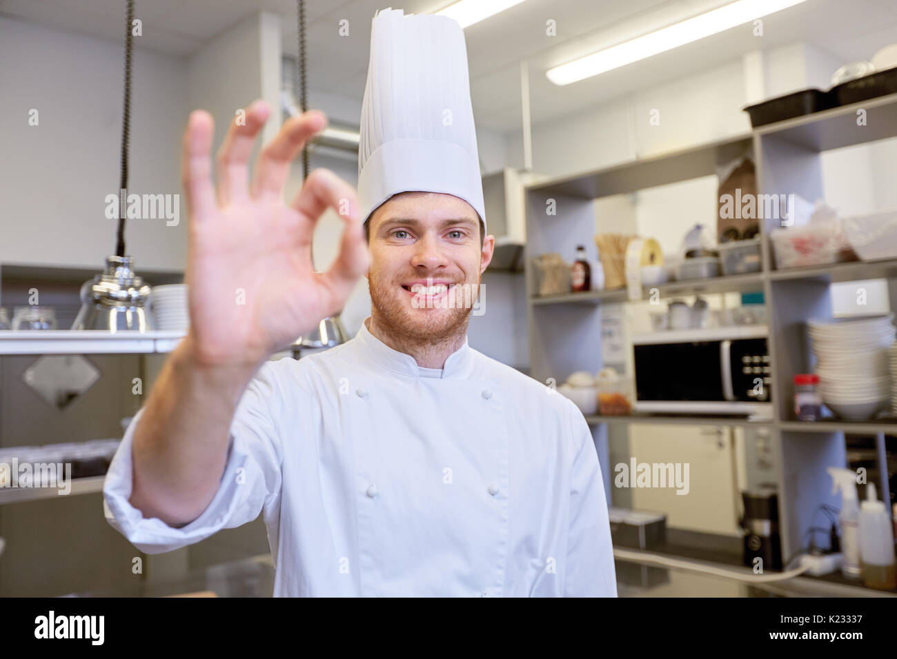happy chef at restaurant kitchen showing ok sign Stock Photo - Alamy