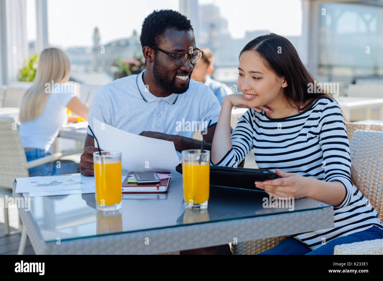 International chatting over homework in cafe Stock Photo - Alamy