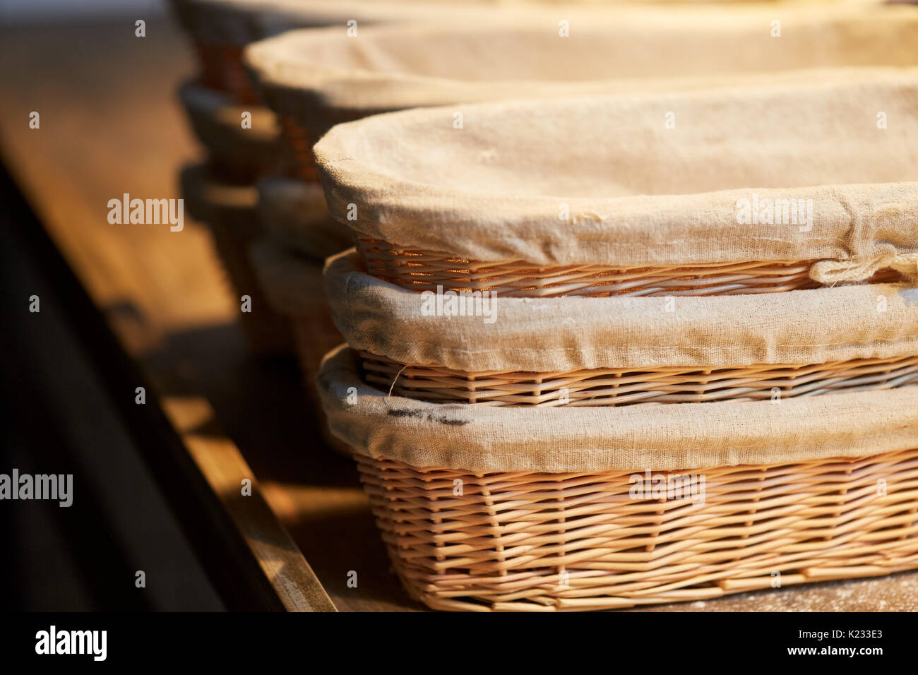 bakery wicker baskets on wooden kitchen table Stock Photo - Alamy