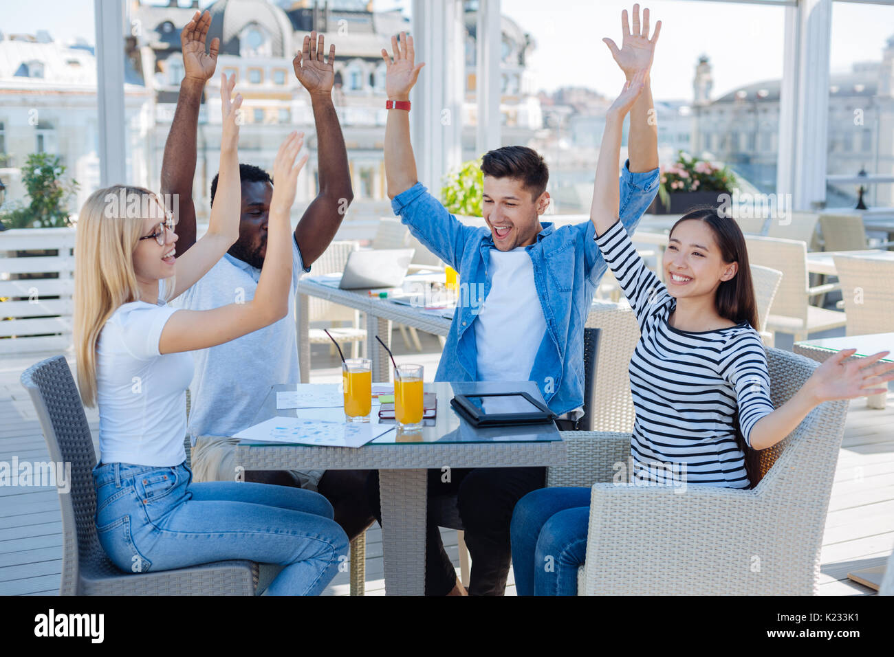 Cheerful raising hands with excitement Stock Photo - Alamy