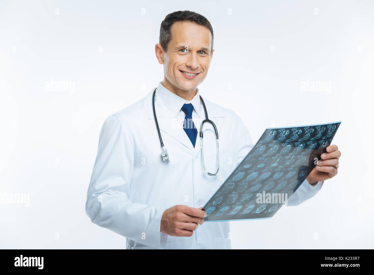 Radiant doctor posing with x ray scan of human head Stock Photo - Alamy