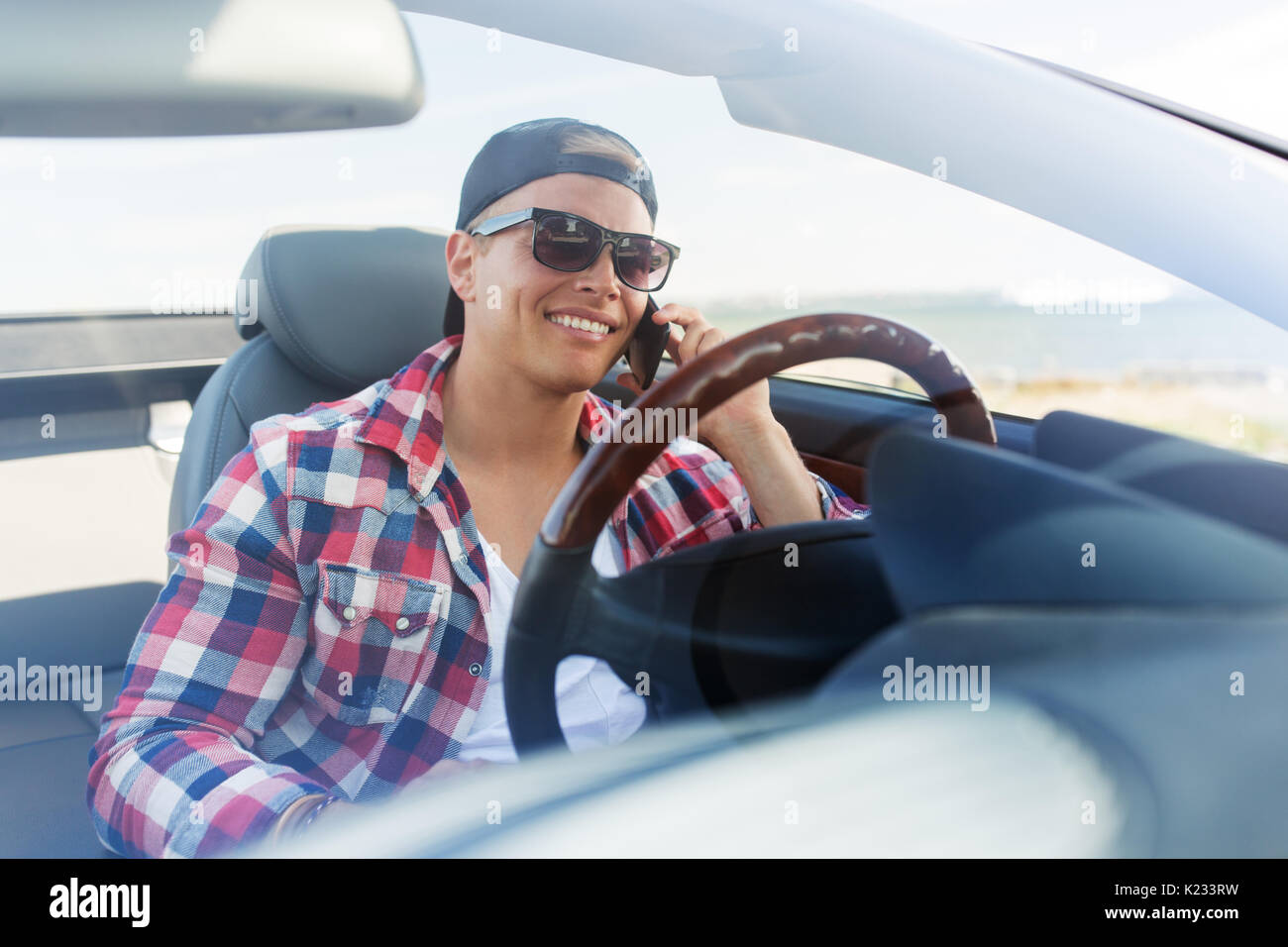 happy man calling on smartphone in convertible car Stock Photo - Alamy