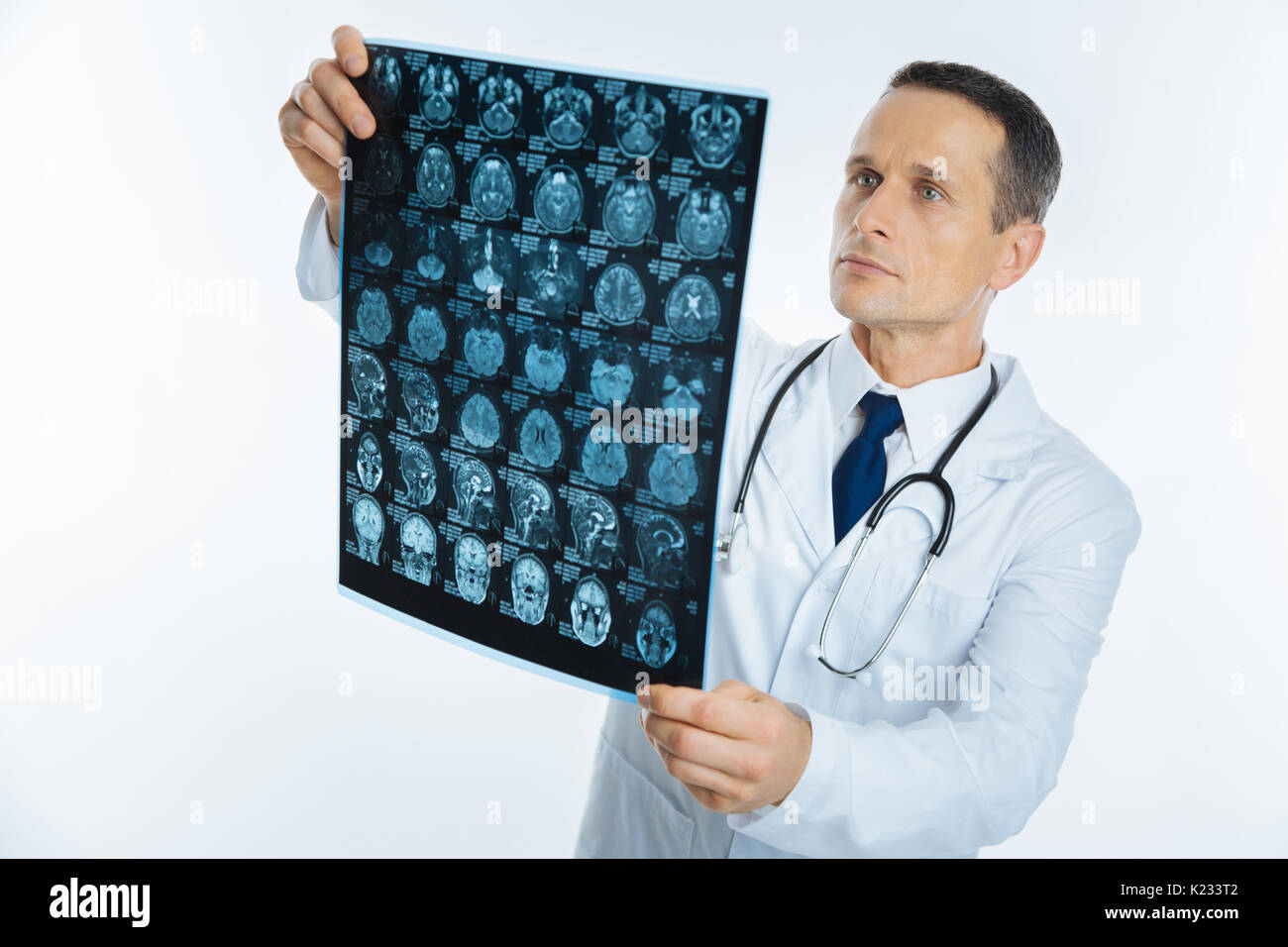 Smart male practitioner examining mri scan image Stock Photo - Alamy