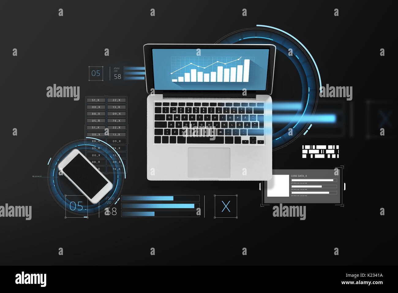 laptop with chart on screen and smartphone Stock Photo - Alamy