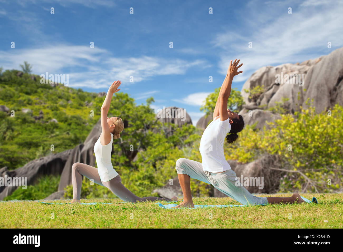 couple making yoga in low lunge pose outdoors Stock Photo - Alamy