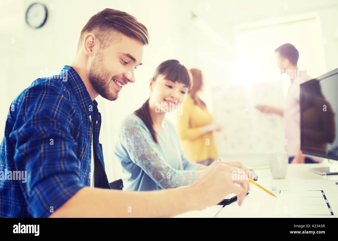 creative team with blueprint at office Stock Photo - Alamy